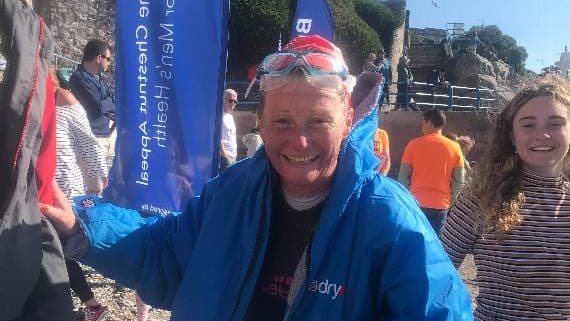 Howling winds, big waves and a sprained wrist no match for swimmer ...